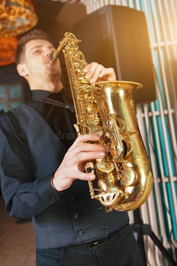 Young Man Plays a Musical Instrument Saxophone Stock Photo - Image of ...