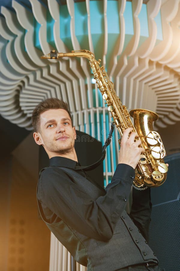 Young Man Plays a Musical Instrument Saxophone Stock Image - Image of ...