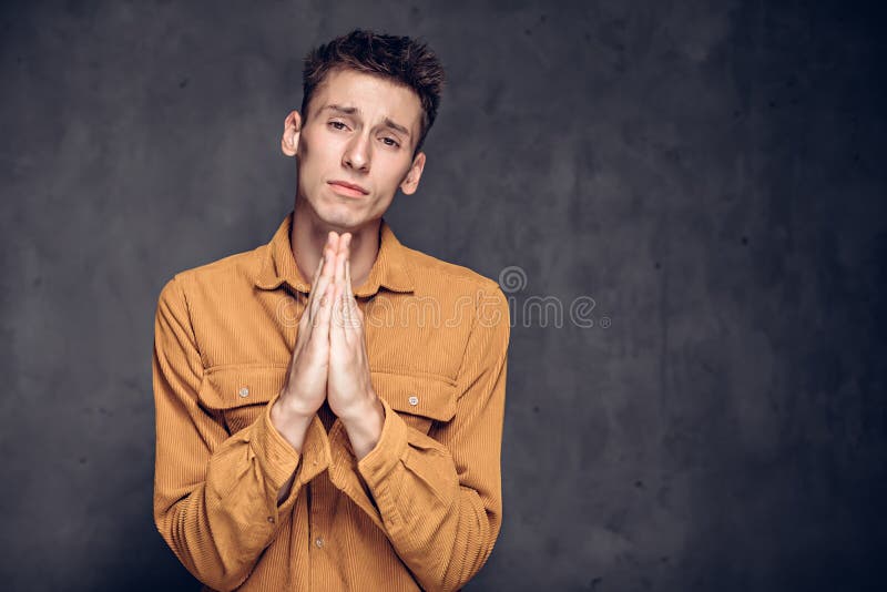 Young Man with Please Gesture on Dark Background Stock Photo - Image of ...