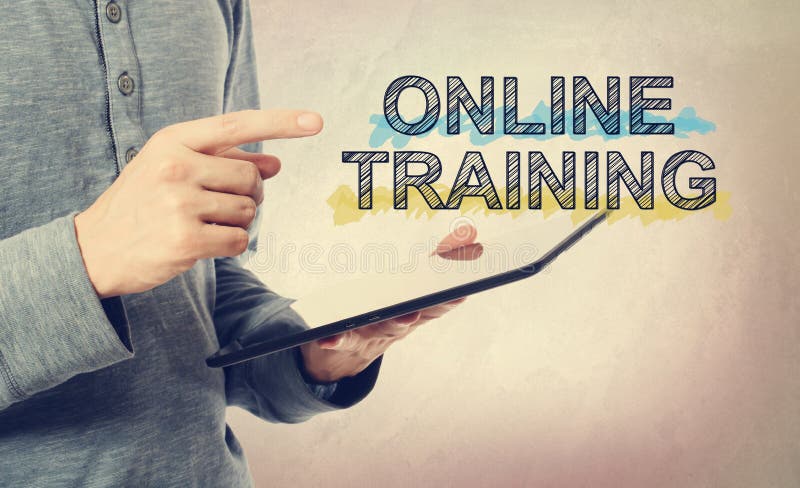 Young Man Pointing at Online Training Text Over Tablet Computer Stock ...