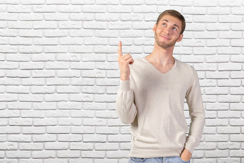 Young man pointing up stock image. Image of lifestyle - 69703811