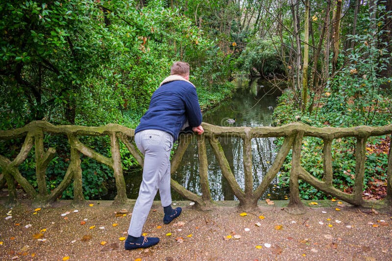 Young Man Posing on Bridge with Stone Railing Stock Image - Image of ...