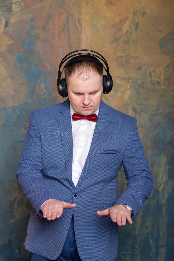 Young Man Posing with Headphones in the Studio. the Concept of Music ...