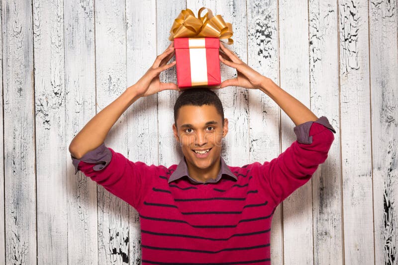 Young Man Posing with a Present in Studio Stock Image - Image of ...
