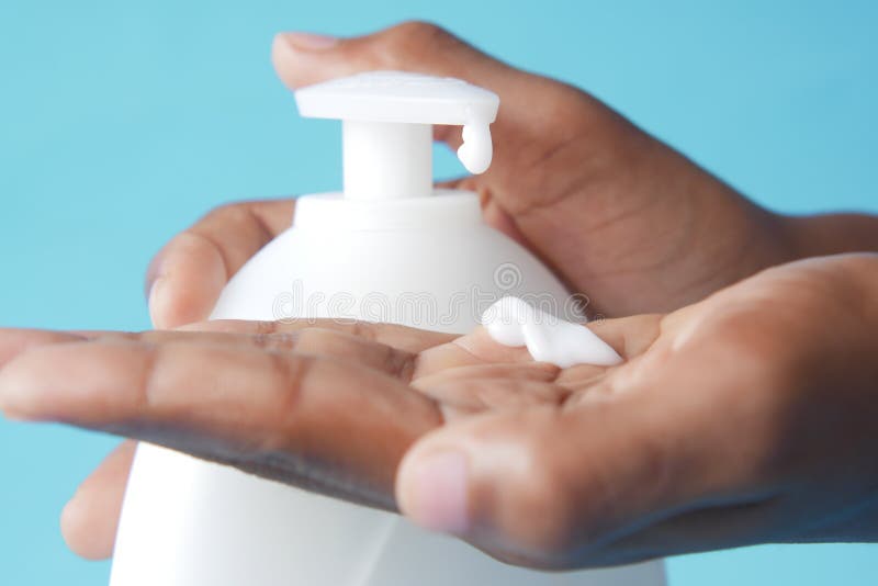 Young Man Pouring Moisturizing Cream from a Container Stock Photo ...