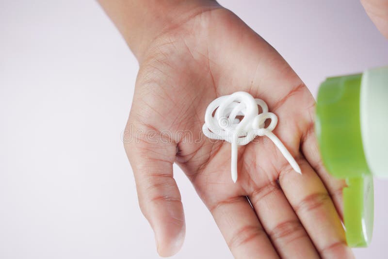 Young Man Pouring Moisturizing Cream from a Container Stock Image ...