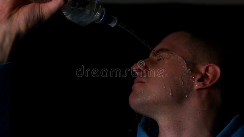 Young Man Pouring Water from Bottle Over Face Stock Footage - Video of ...