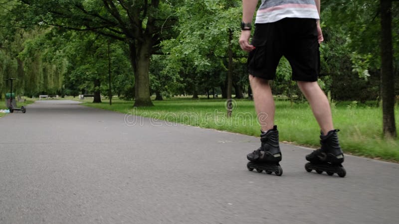 Young Man Practicing Roller Scating in Park Stock Video - Video of ...