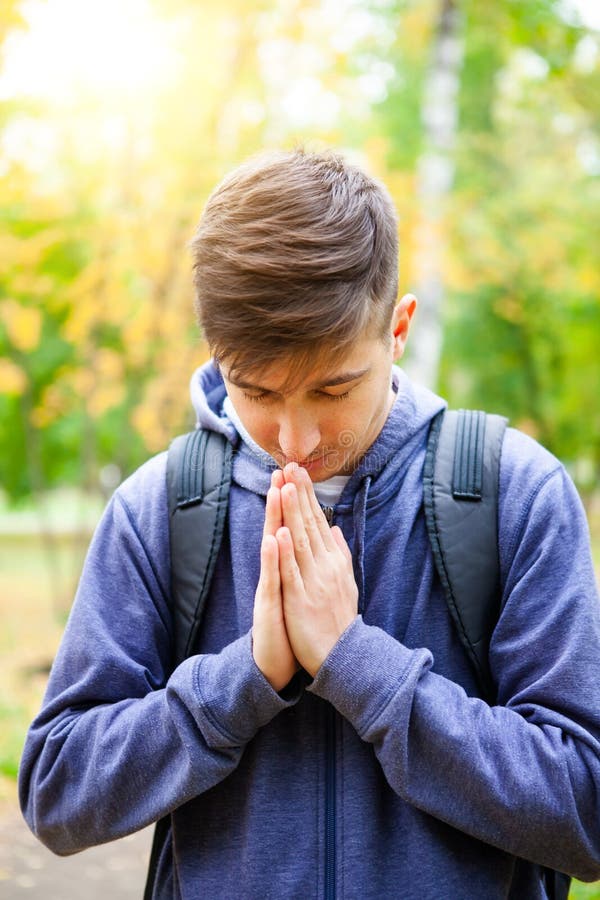 Young Man praying stock image. Image of calm, outside - 195692727