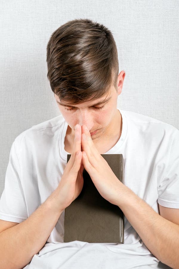Young Man is praying stock photo. Image of religion - 200534528