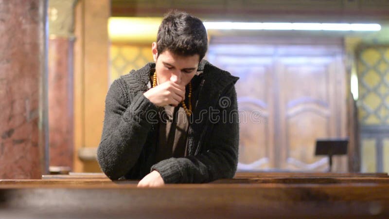 Young Man Praying in Church Stock Video - Video of spiritual, religious ...