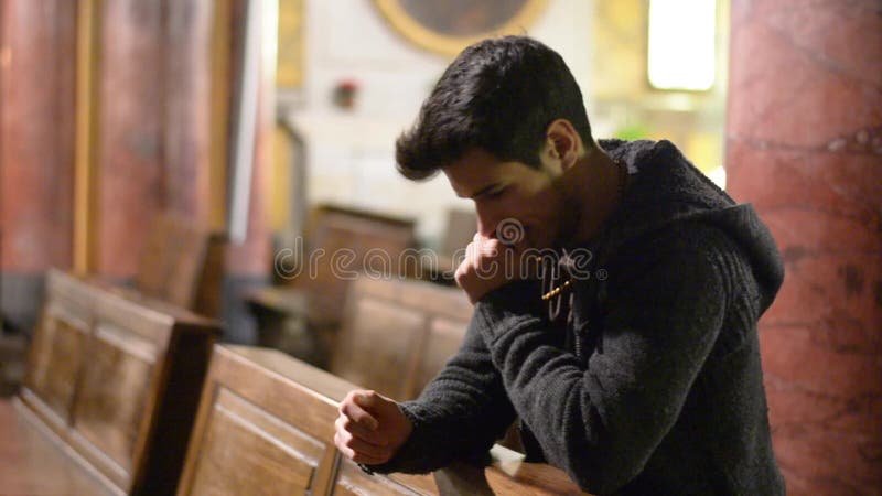 A Young Man Praying To God. the Prayer is Performed in the House Stock ...