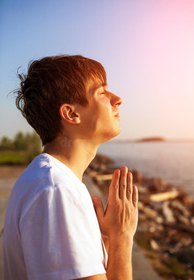 Young Man praying stock photo. Image of arms, rural, idyllic - 98465300