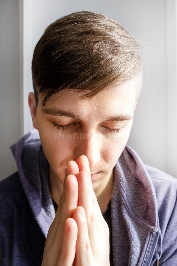 Young Man praying stock photo. Image of prayer, entreaty - 215335978