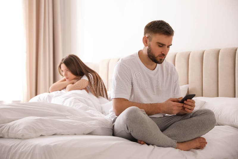 Young Man Preferring Smartphone Over Girlfriend on Bed at Home ...