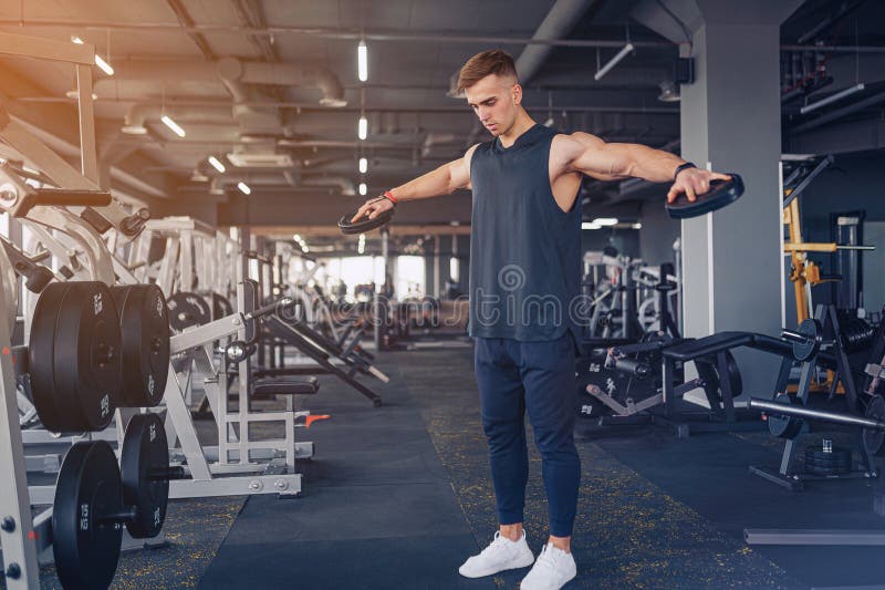 Young Man Preforming Dumbbell Lateral Raise - Exercise for Shoulders ...