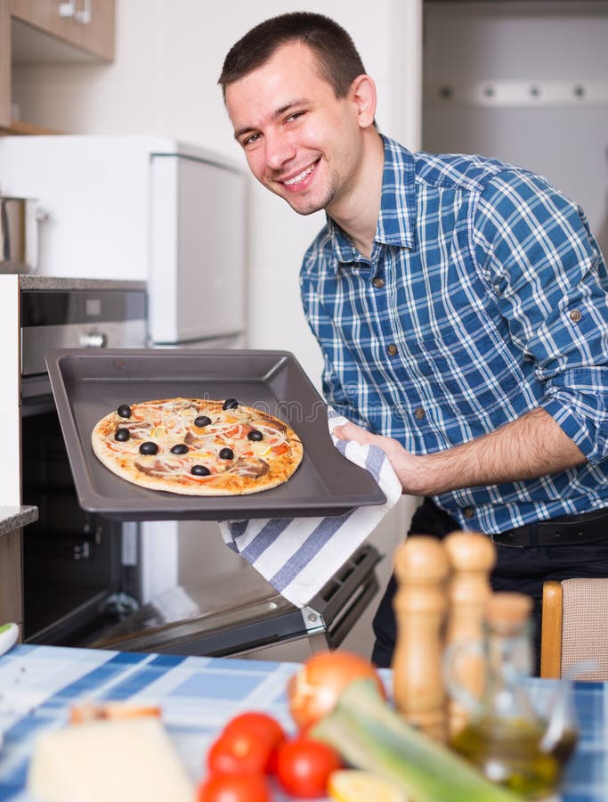 Young Man Preparing Delicious Pizza in Oven Stock Image - Image of ...
