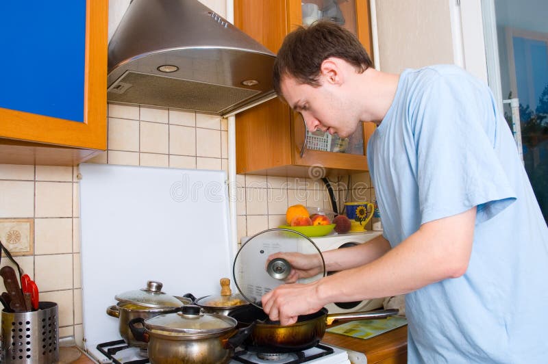 Young man preparing food stock photo. Image of scoop - 20138360
