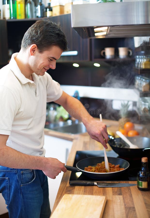 Young man preparing lunch stock photo. Image of indoors - 18311056