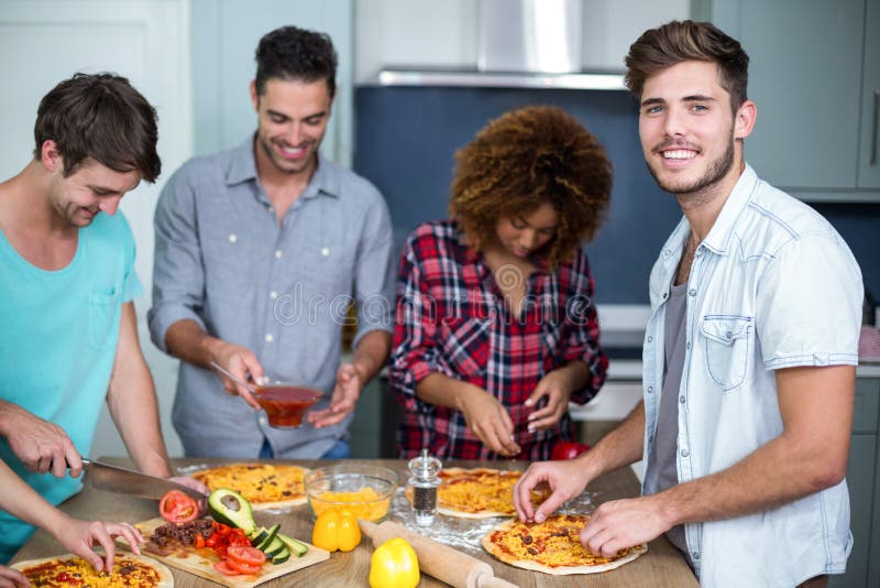Young Man Preparing Pizza with Friends on Table Stock Image - Image of ...