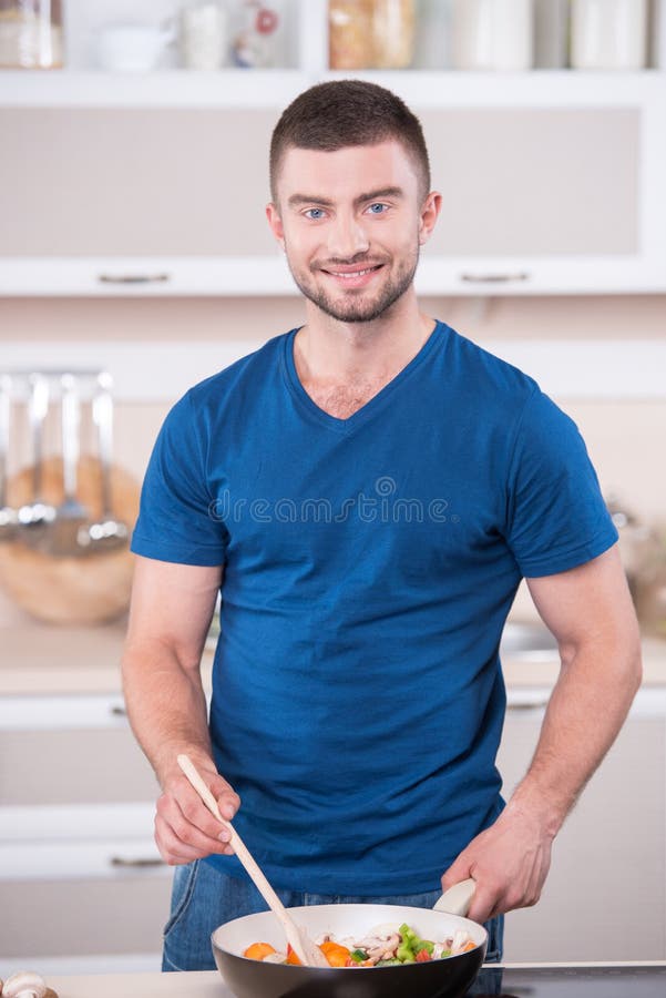 Young Man Preparing Supper in the Kitchen Stock Photo - Image of ...