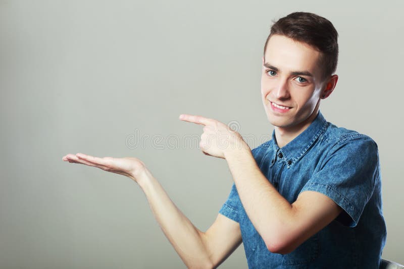 Young man is presenting stock photo. Image of presenter - 68472692