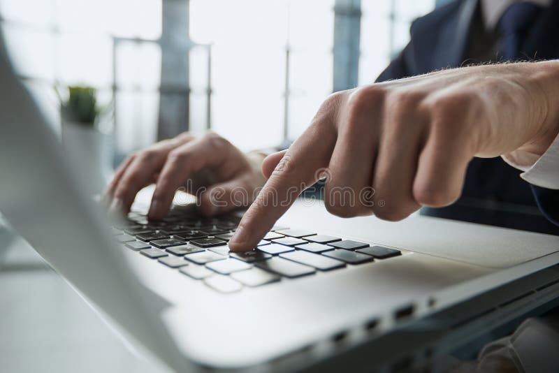 Young Man Presses His Finger on the Computer at the Table in the Office ...