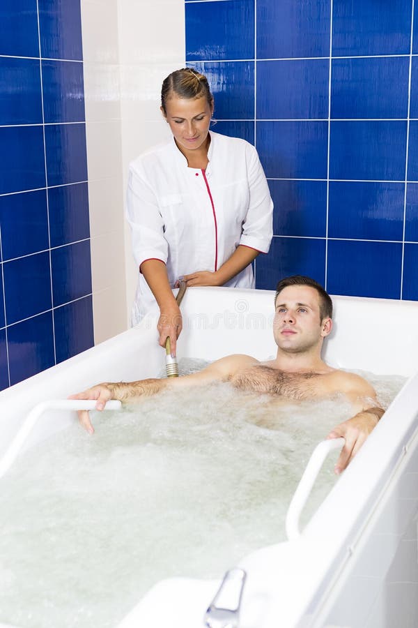 Young Man is the Procedure in the Whirlpool Hydrobath Stock Photo ...