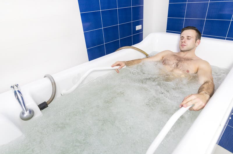 The Young Man is the Procedure in Whirlpool Hydrobath. Stock Photo ...