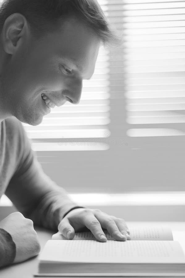 Young Man Profile Sitting at Table and Reading. Stock Image - Image of ...