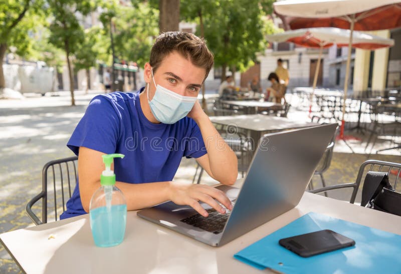 Young Man with Protective Face Mask and Hand Sanitizer Outdoors Working ...