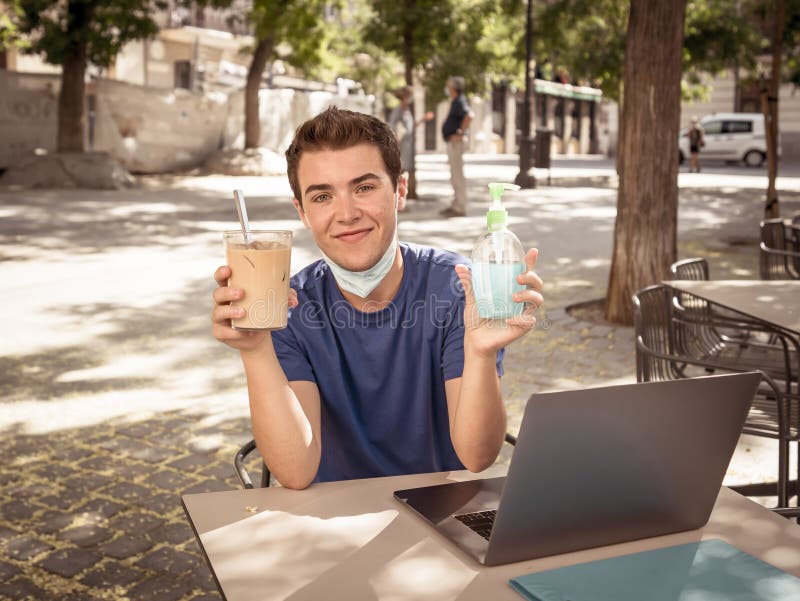 Young Man with Protective Face Mask and Hand Sanitizer Outdoors Working ...