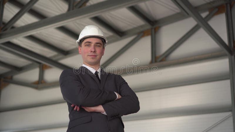 A Young Man in a Protective Helmet and Shows a Thumb at a Construction ...