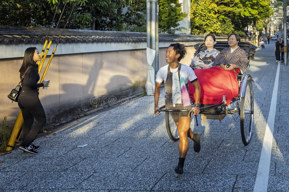 Young Man Pulling a Rickshaw with Passengers in Kimonos in Kyoto ...