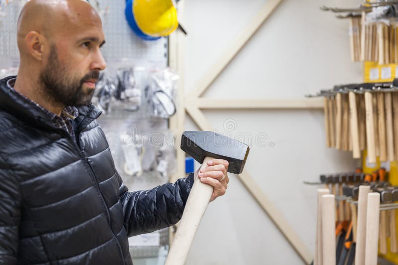 Young Man Purchasing a Hand Tool in Hardware Shop Stock Photo - Image ...
