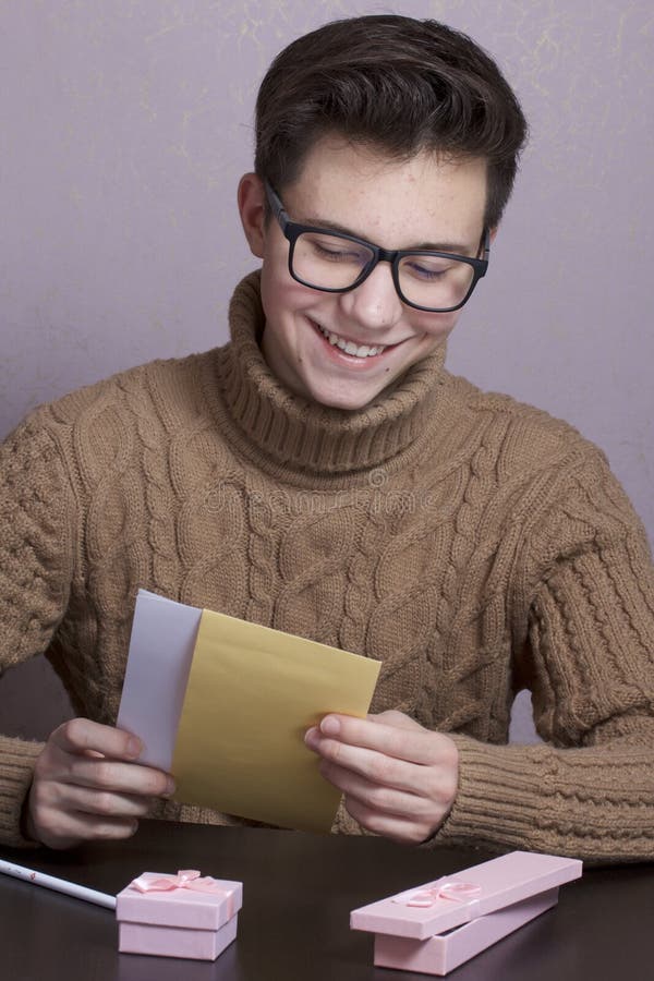 The Young Man Puts in the Envelope Congratulations on the Holiday ...