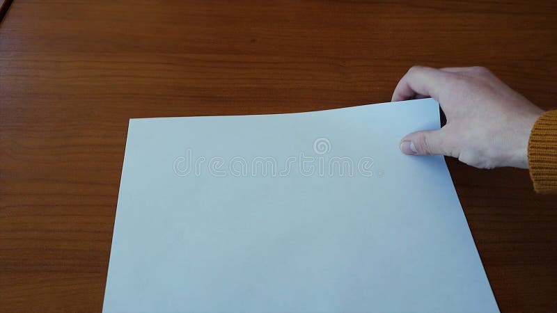 The Young Man Puts on the Table a White Sheet of Paper. Getting Started ...