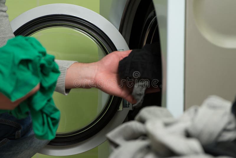 Young Man Putting a Cloth into Washing Machine Stock Image - Image of ...