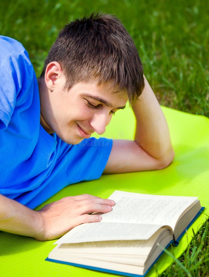 Young Man read a Book stock photo. Image of grass, garden - 205896458