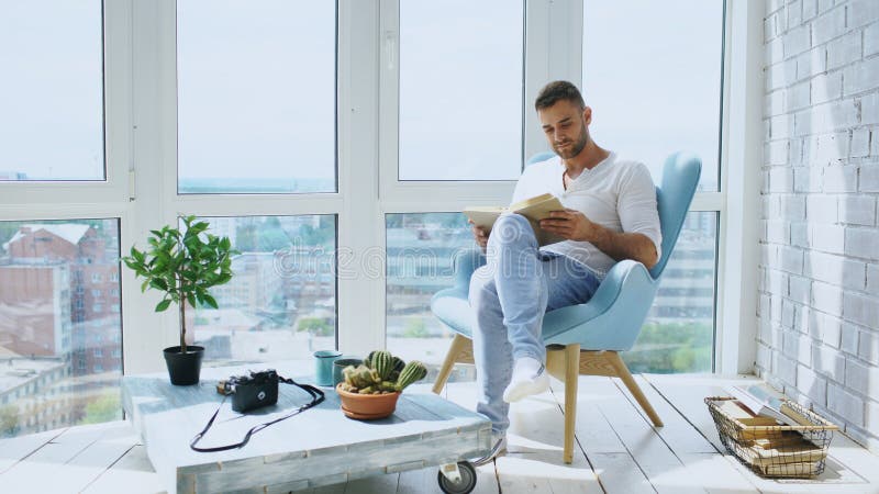 Young Man Read Book Sitting on Balcony in Modern Apartment Stock Image ...
