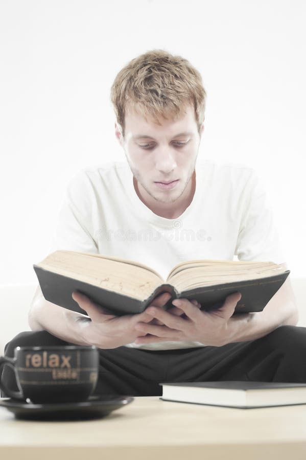 Young man reading stock image. Image of holding, joyful - 17918555