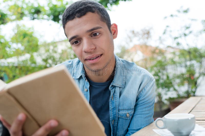 Young man reading book stock photo. Image of people - 152588198