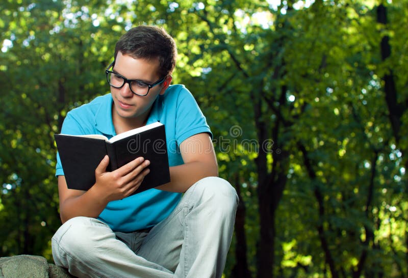 Young man reading book stock image. Image of tree, reading - 16110143
