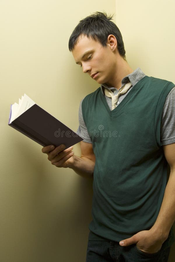 Young man reading book stock image. Image of enthralled - 5621547