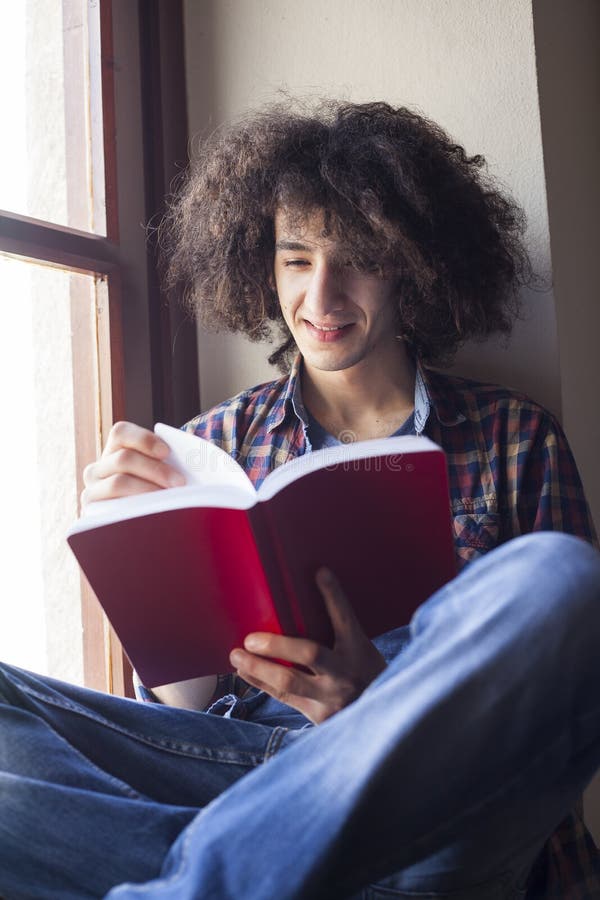 Young man reading book stock photo. Image of reading - 68811140