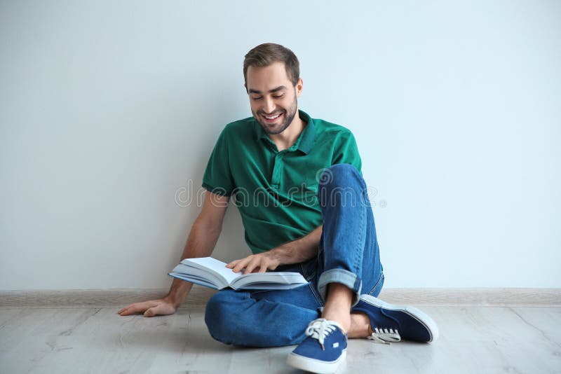 Young Man Reading Book on Floor Stock Image - Image of life, leisure ...