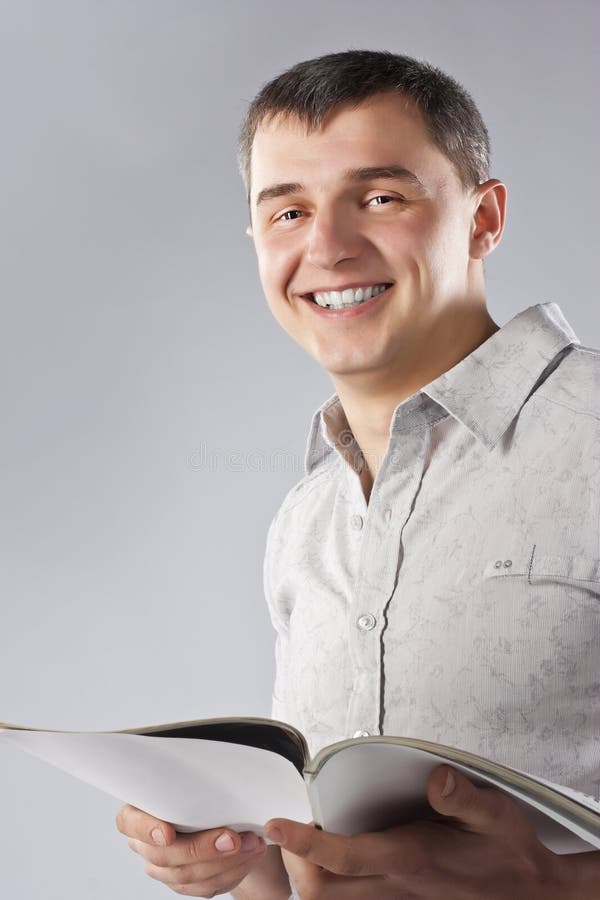 Young Man Reading a Book, on Grey Stock Photo - Image of modern ...