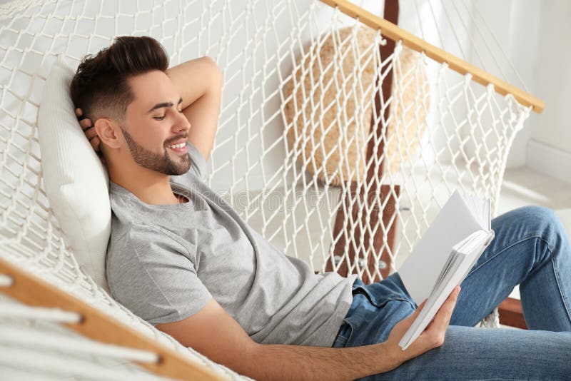 Young Man Reading Book in Hammock Stock Photo - Image of person ...