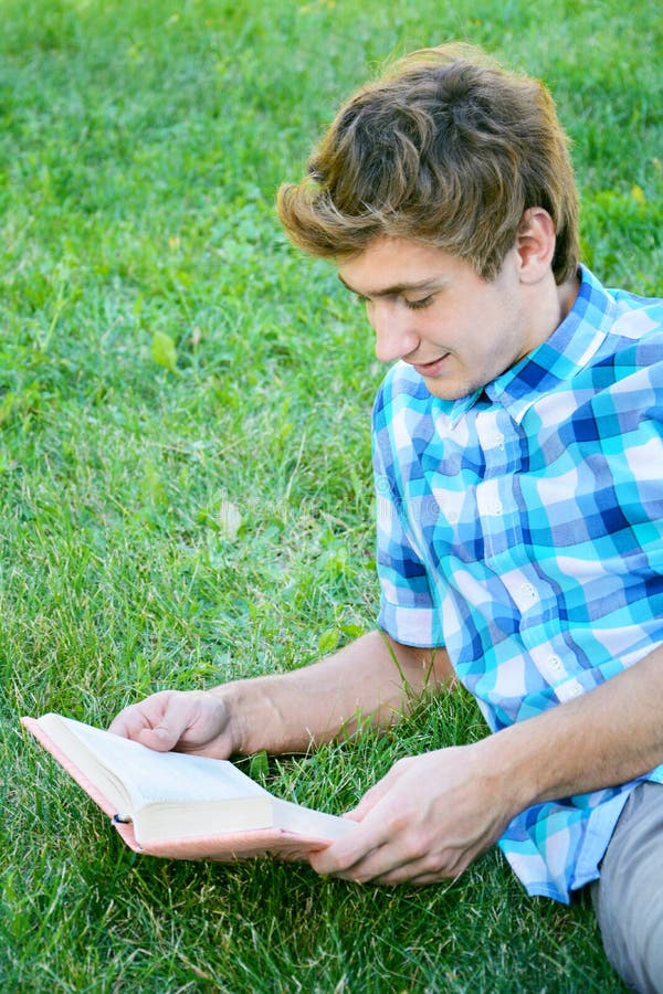 Young Man is Reading a Book Stock Photo - Image of people, green: 64874390