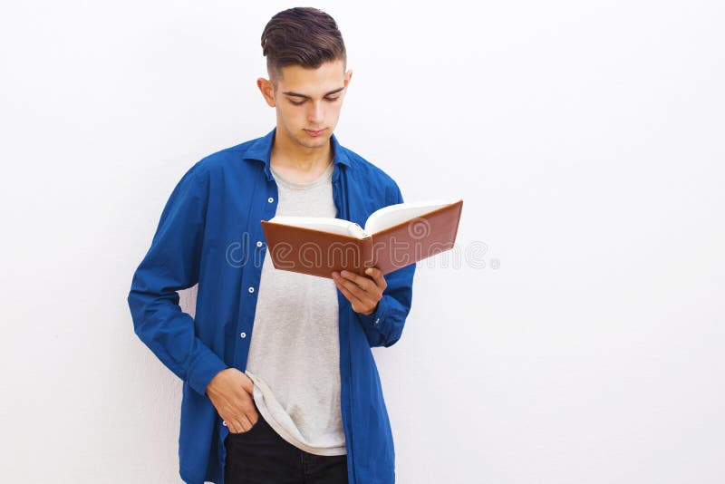 Young man reading the book stock photo. Image of indoors - 107288508